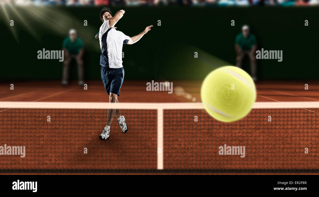 Tennis player playing on a clay tennis court Stock Photo - Alamy