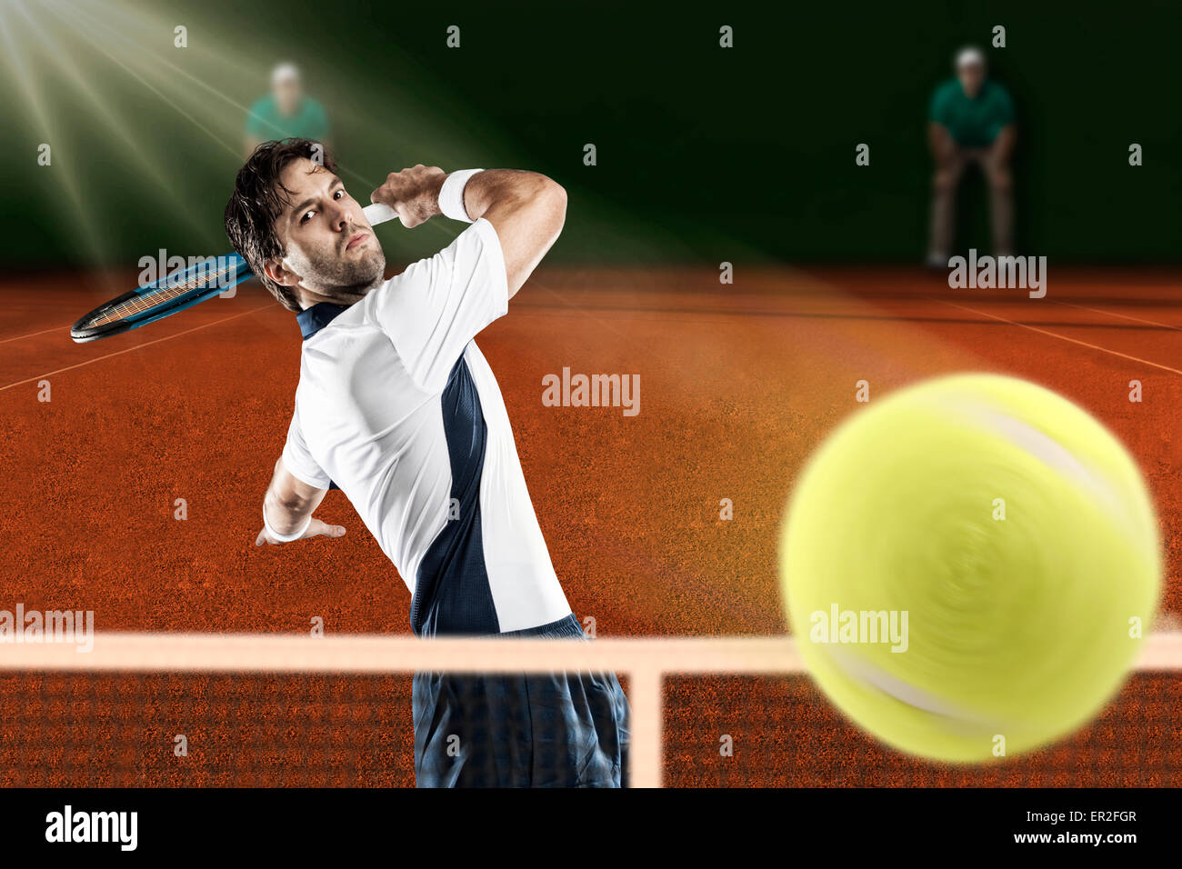 Tennis player playing on a clay tennis court Stock Photo - Alamy