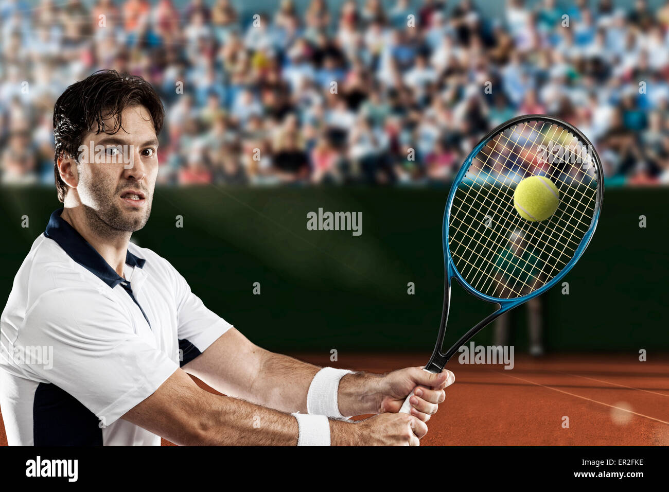 Tennis player playing on a clay tennis court Stock Photo - Alamy