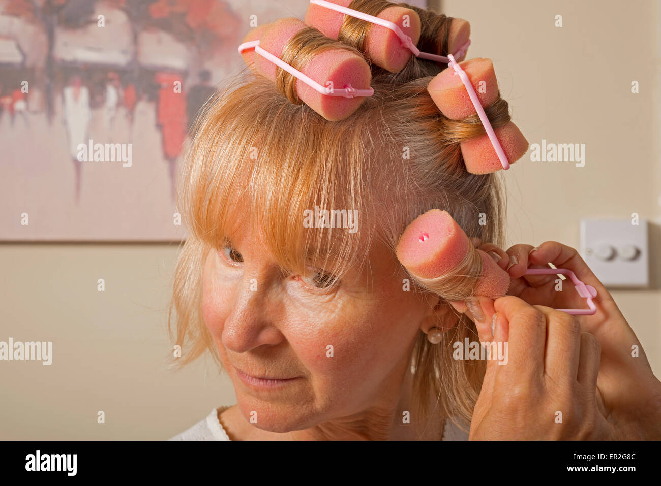 Lady curling her hair home hi-res stock photography and images - Alamy