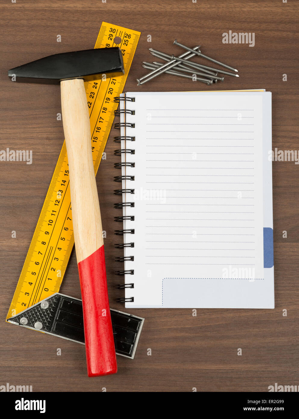 Hammer with note pad and nails Stock Photo - Alamy