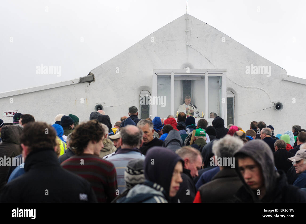 Pilgrims gather at St. Patrick's Chapel at the top of Croagh Patrick ...