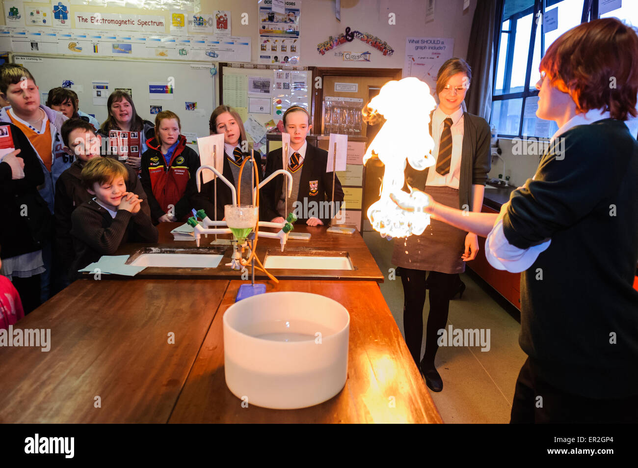 School pupil gives a demonstration of hydrogen gas at a school open day ...