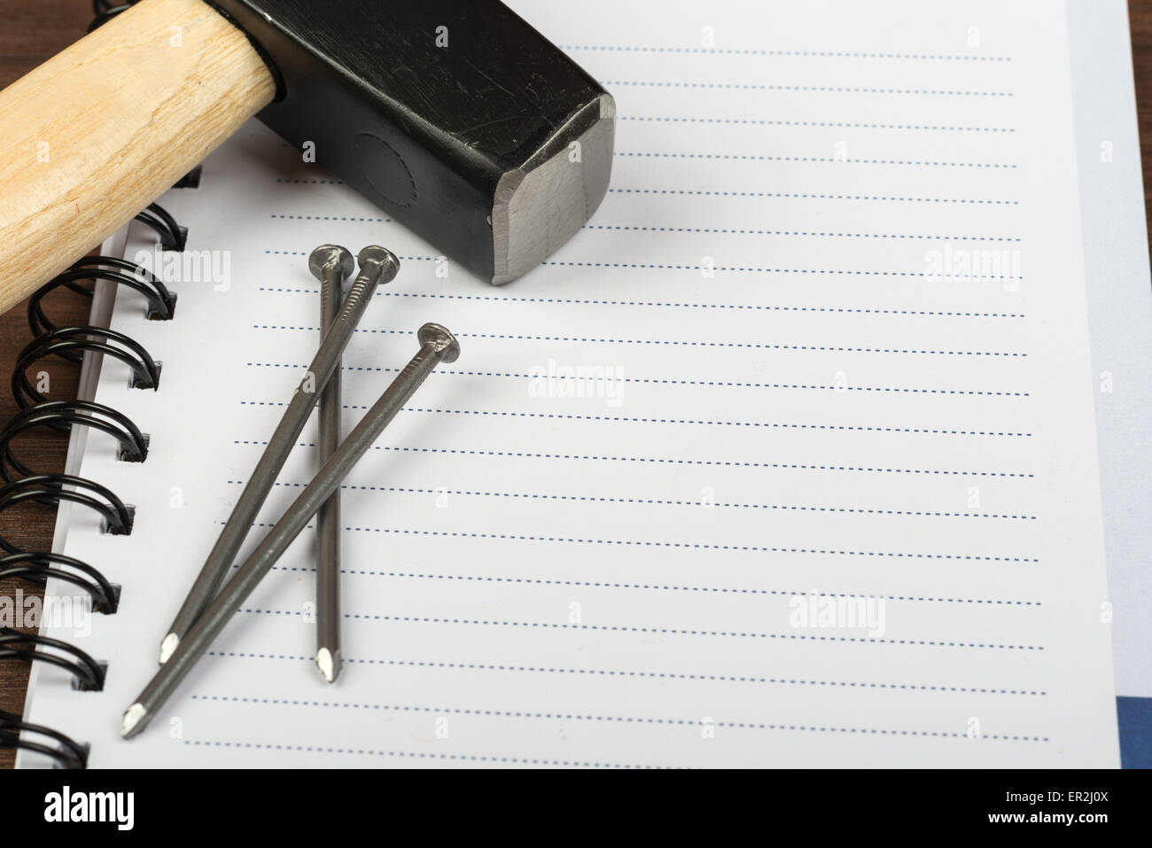 Hammer with nails on note pad Stock Photo - Alamy