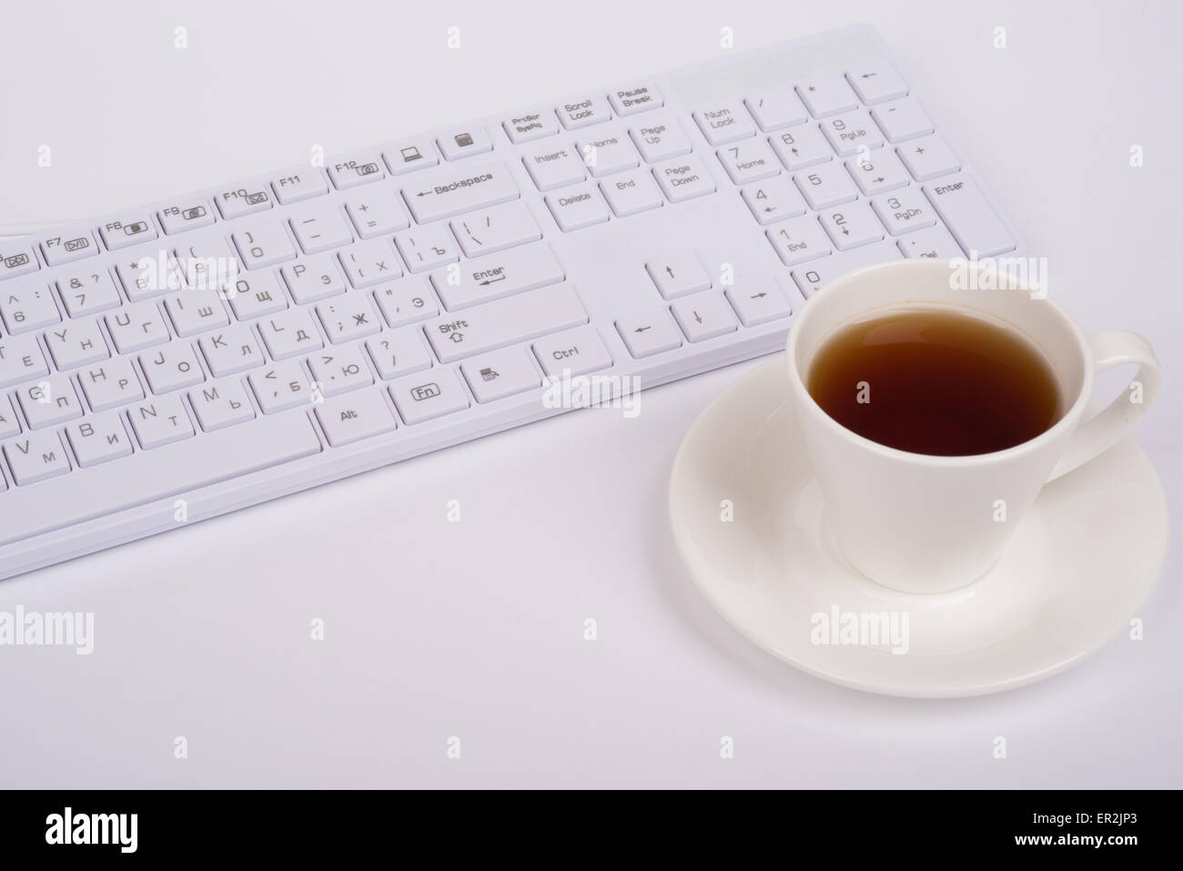 White keyboard and coffee cup Stock Photo - Alamy