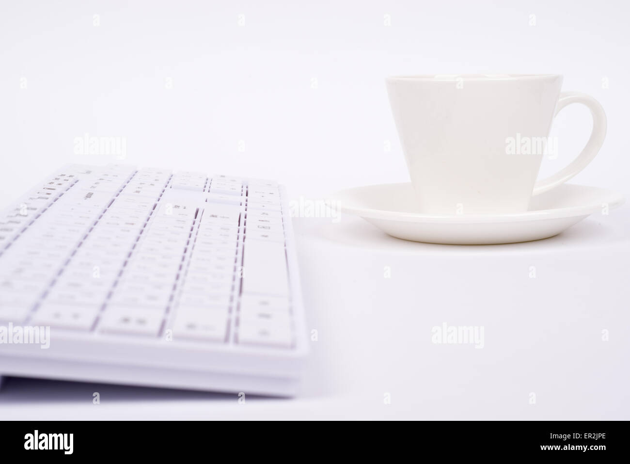 White keyboard and cup Stock Photo - Alamy