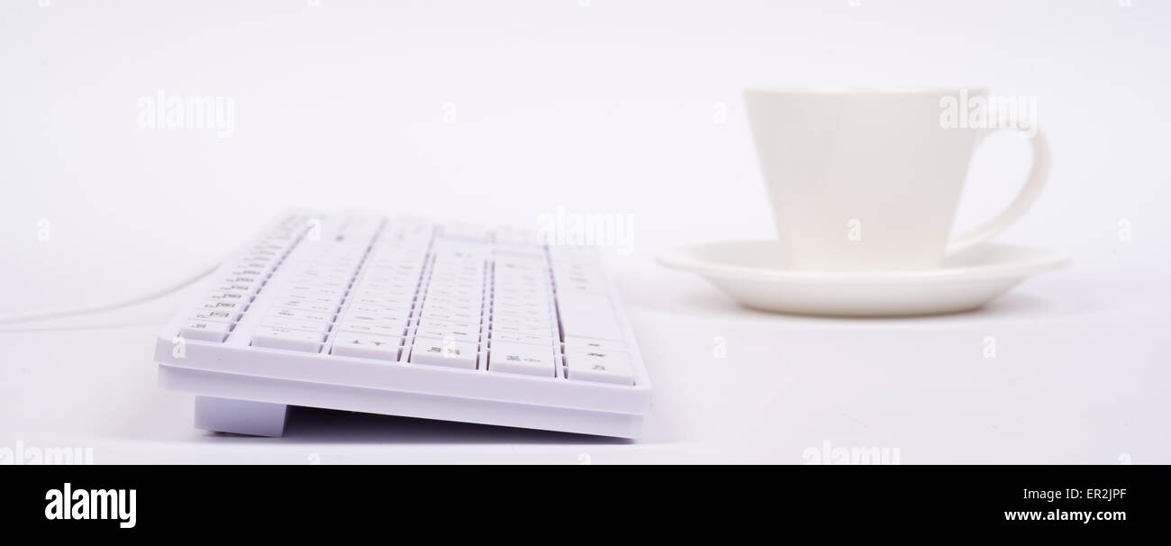 Keyboard and cup Stock Photo - Alamy