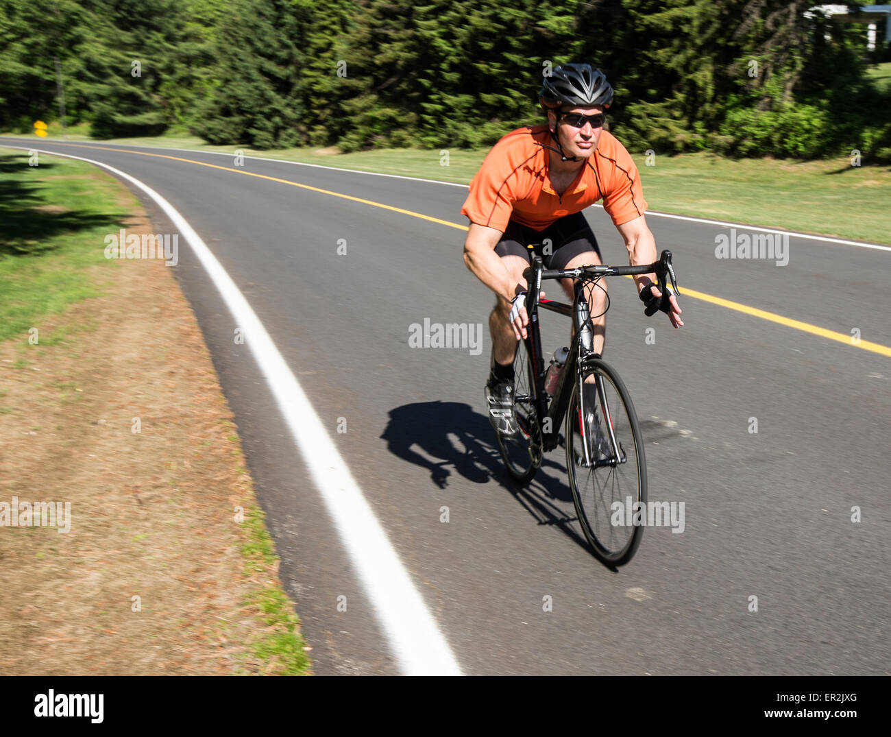 Man riding a road bike on a paved roadway Stock Photo - Alamy