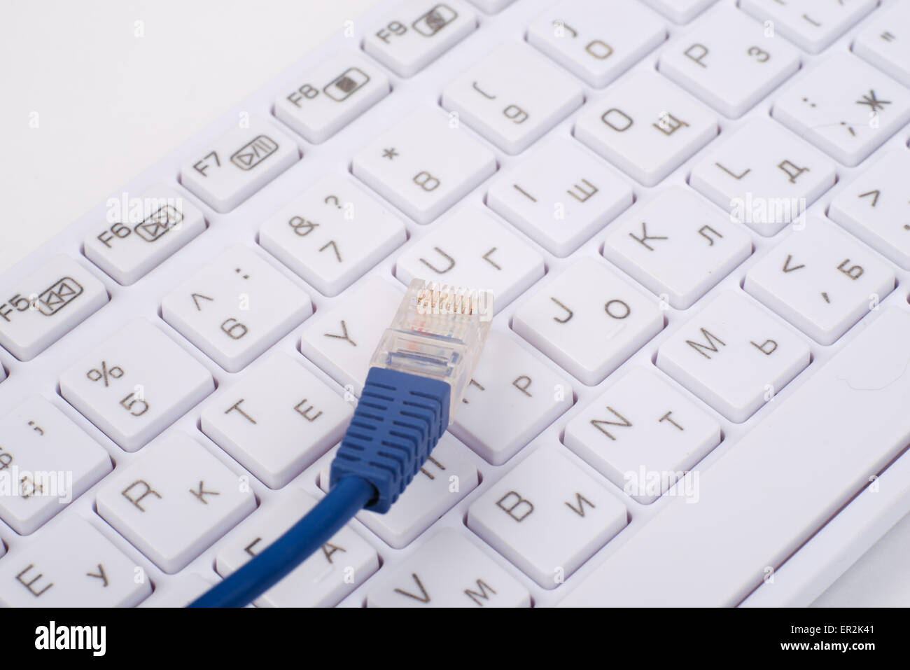 Computer keyboard with cable Stock Photo - Alamy