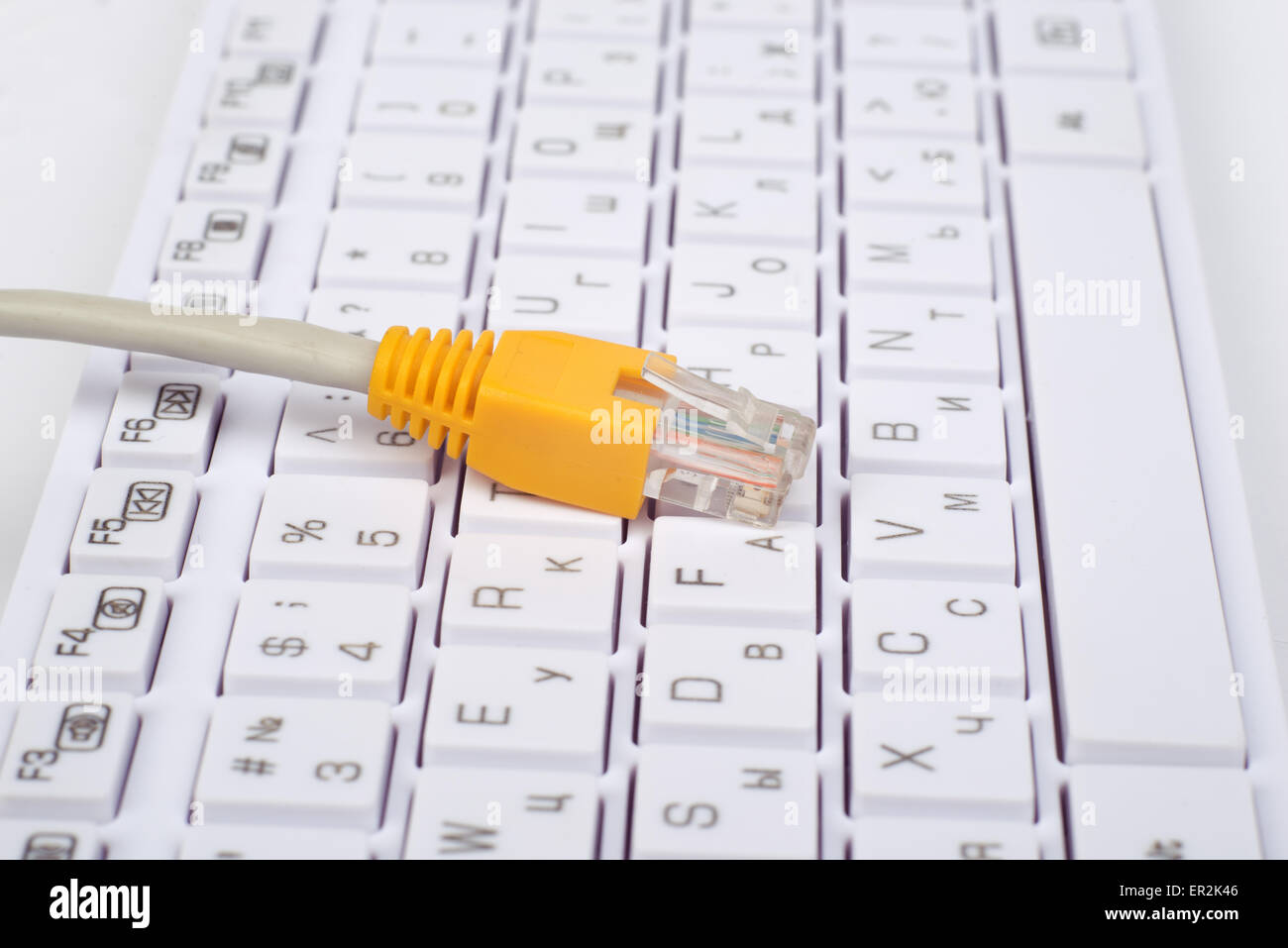 Yellow computer cable on keyboard Stock Photo - Alamy