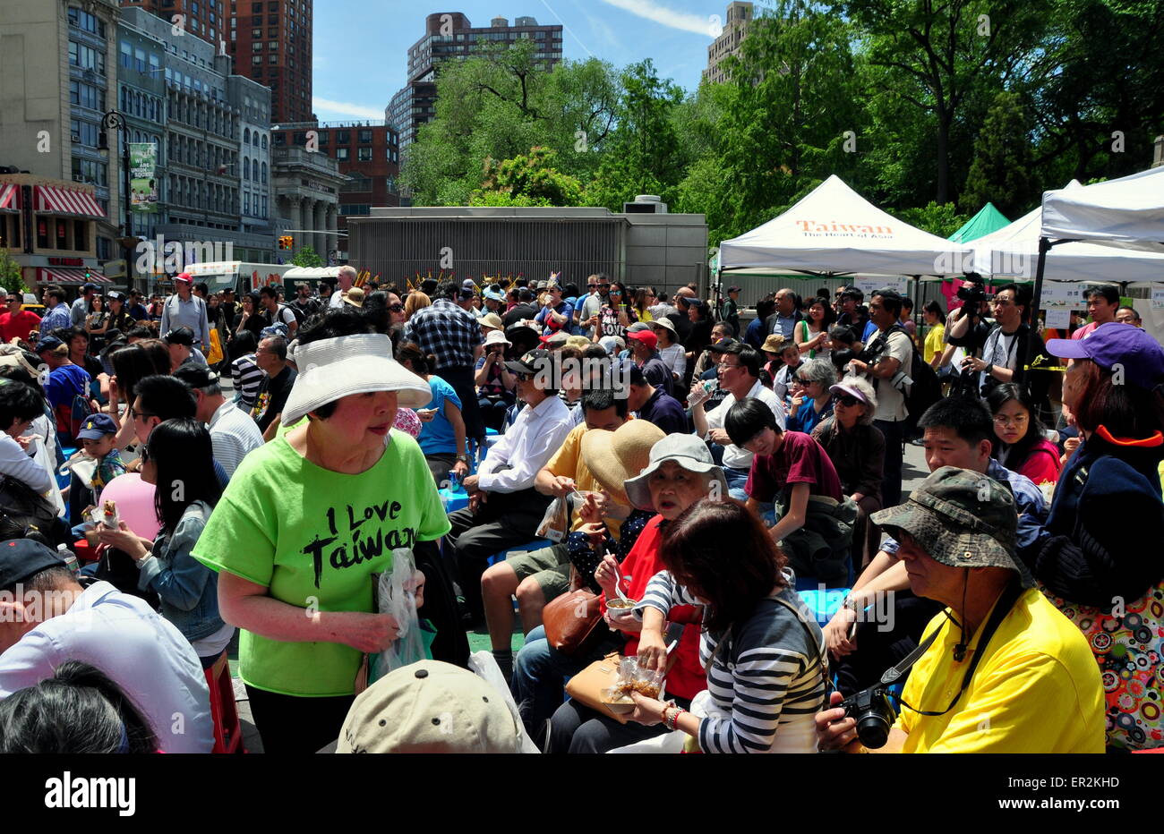 New York City: Crowds of people seated on plastic chairs relaxing and ...