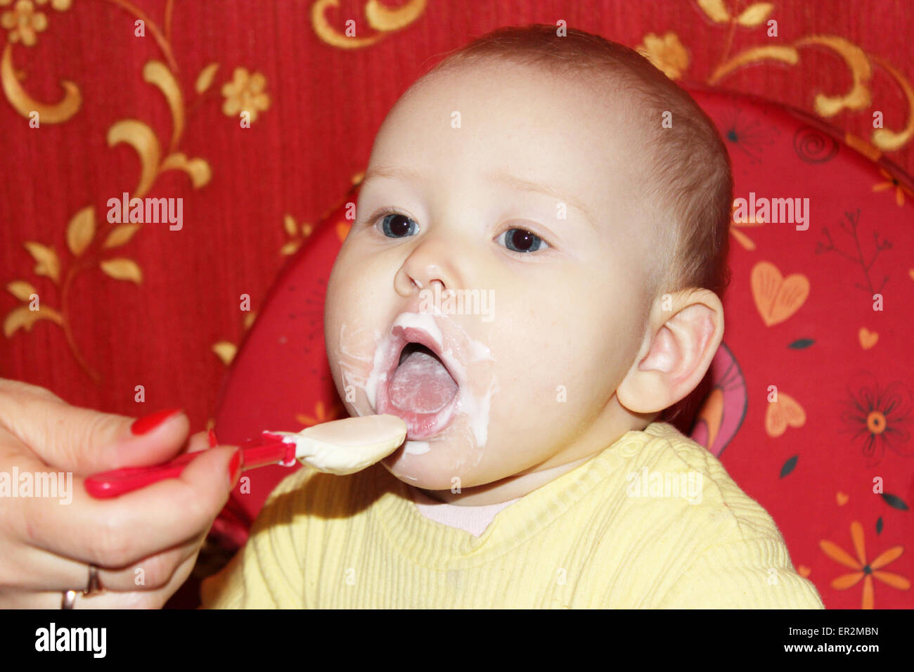 nursing of little baby from childish spoon Stock Photo - Alamy