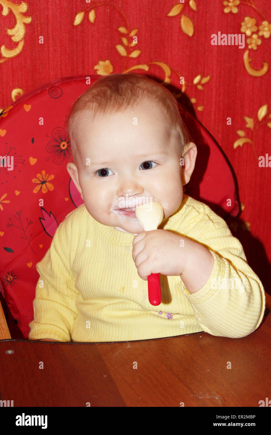 nursing of little baby from childish spoon Stock Photo - Alamy