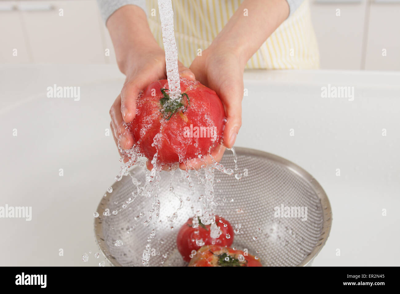 Woman washing tomatoes in hi-res stock photography and images - Alamy