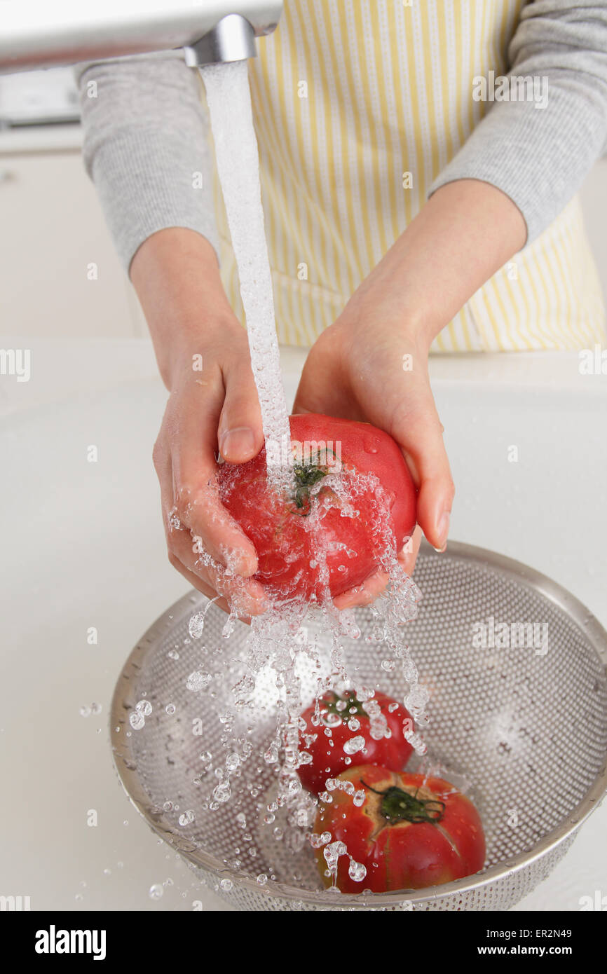 Woman washing tomatoes in hi-res stock photography and images - Alamy