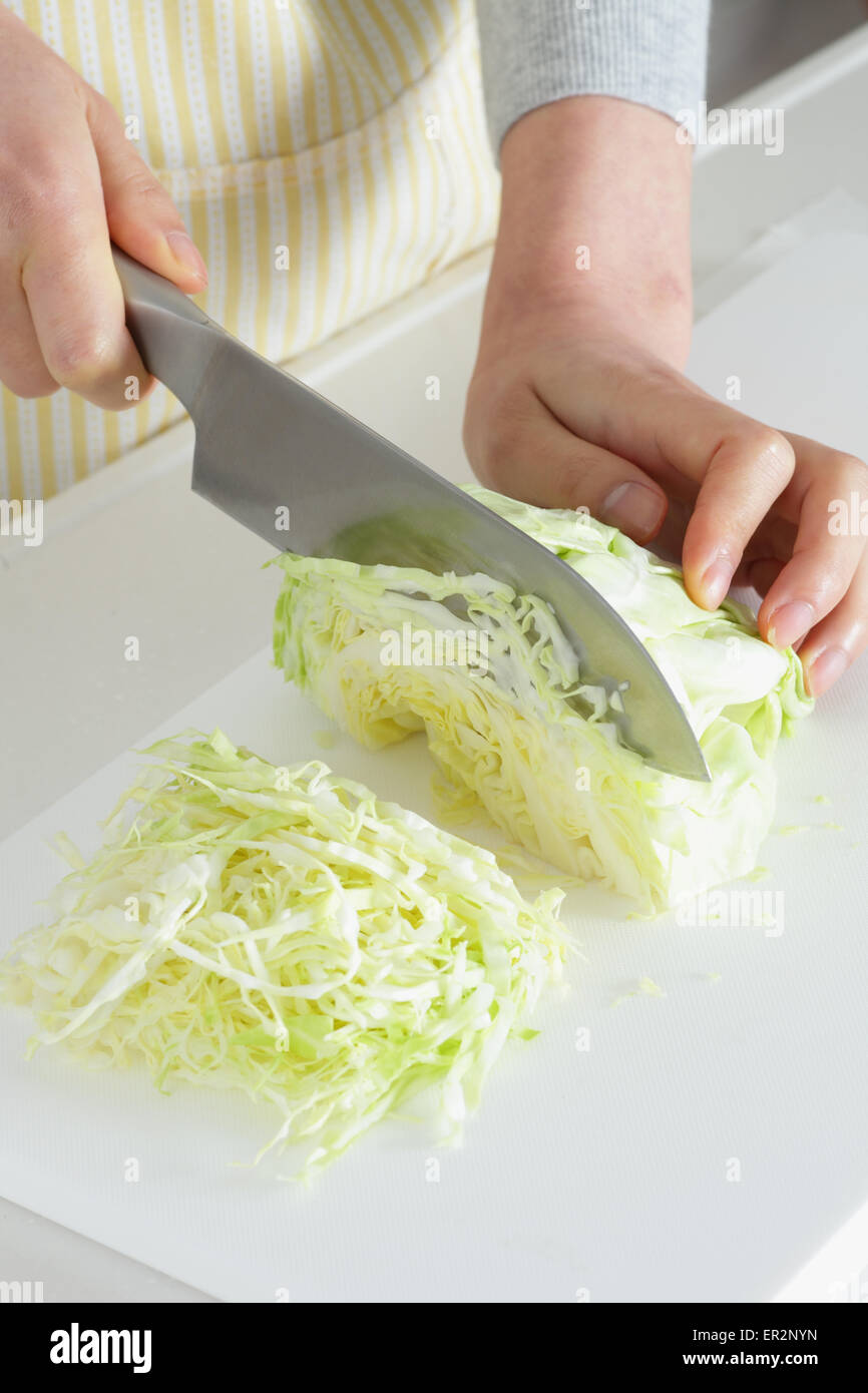 Close up of woman's hands cutting cabbage with a kitchen knife Stock ...
