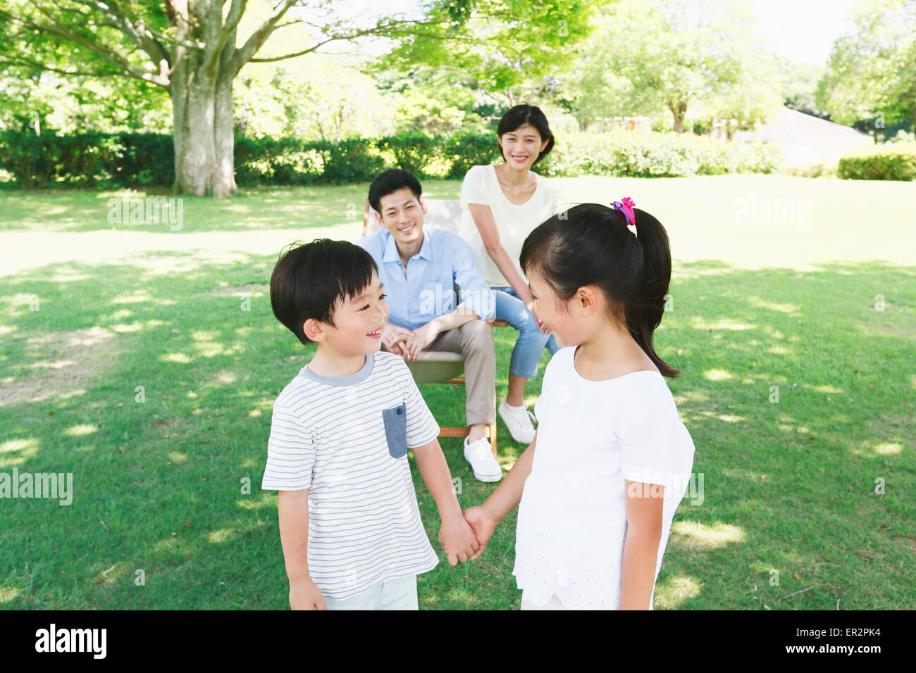 Happy Japanese family in a city park Stock Photo - Alamy
