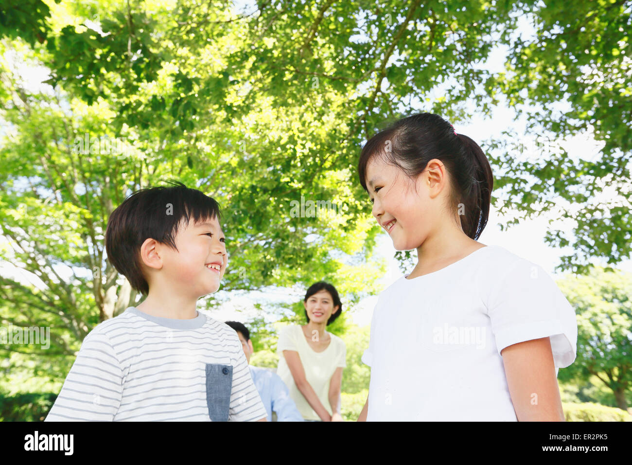 Happy Japanese family in a city park Stock Photo - Alamy