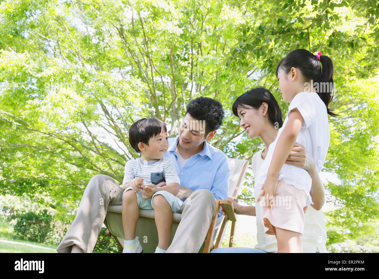Happy Japanese family in a city park Stock Photo - Alamy