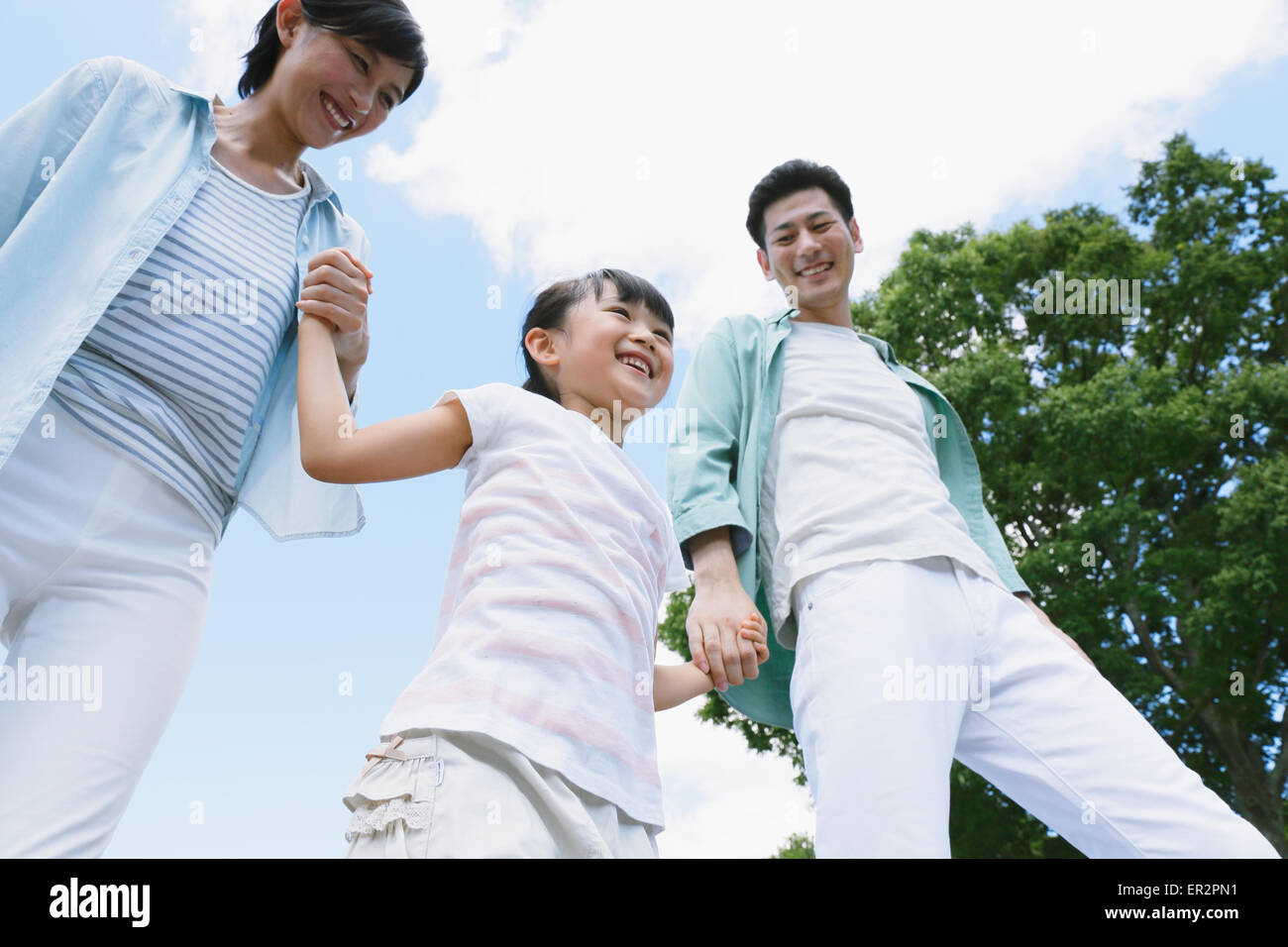 Happy family family in green hi-res stock photography and images - Alamy