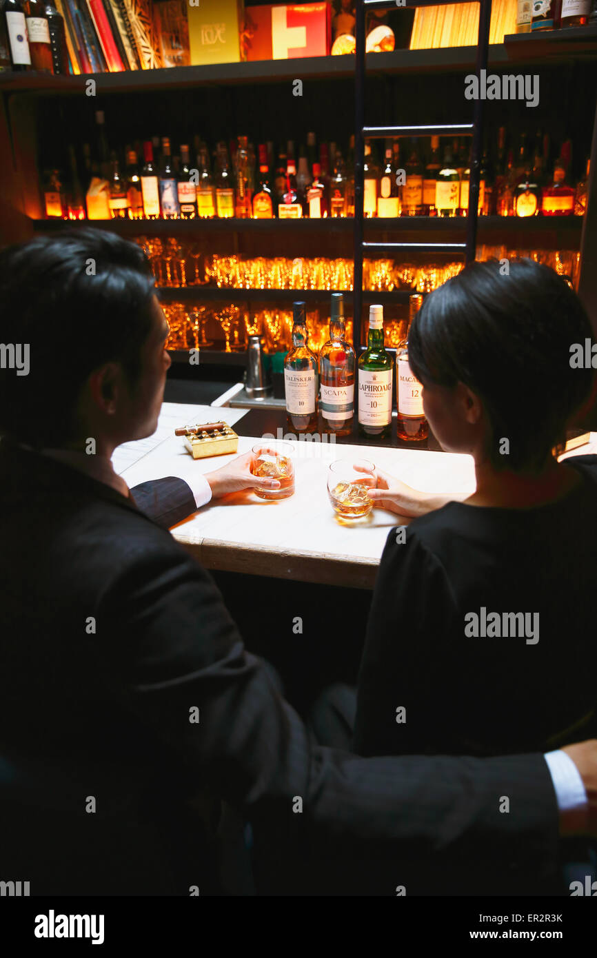 Couple drinking in a fashionable bar Stock Photo - Alamy