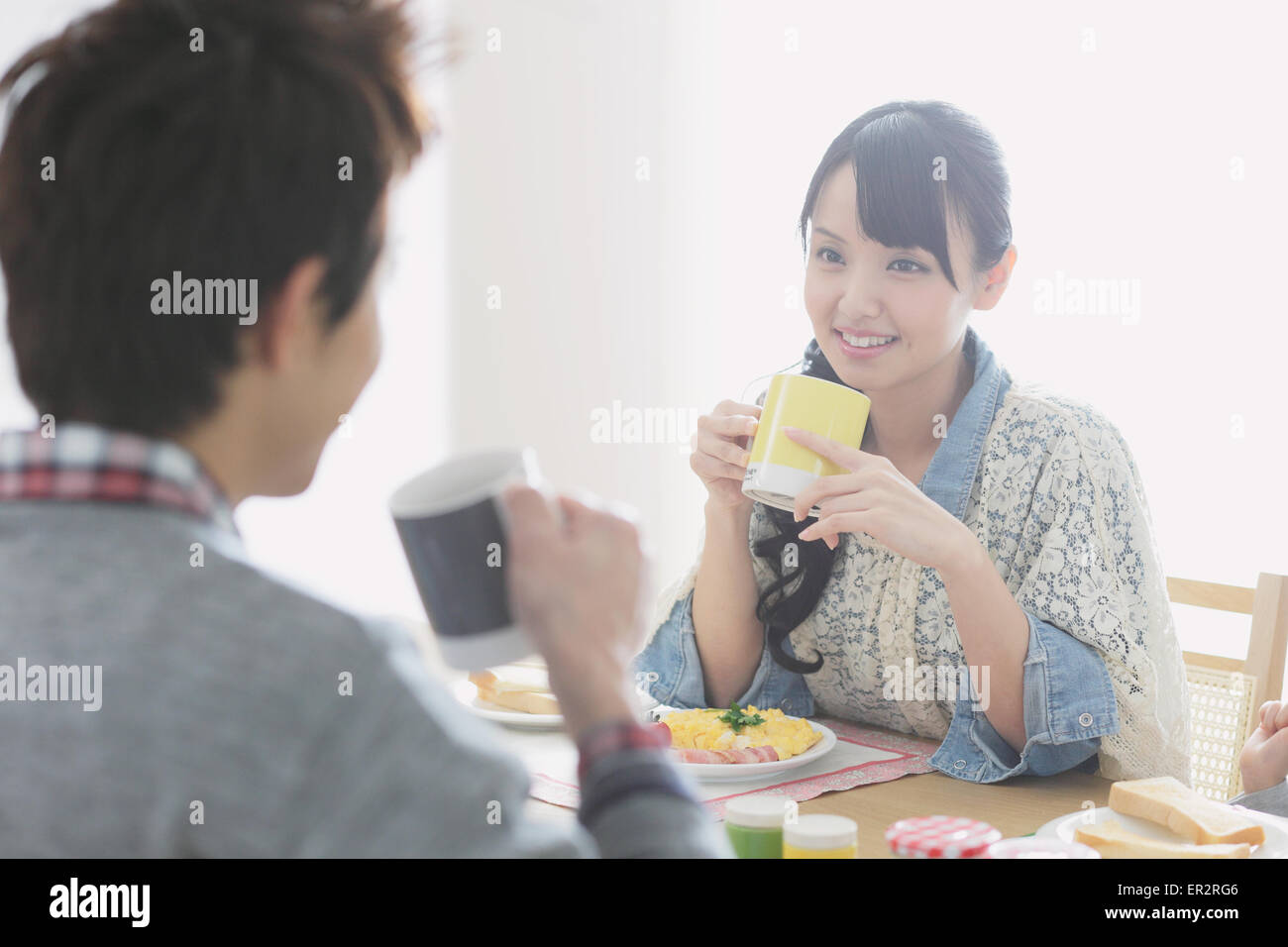 Young adult couple having breakfast in their dining room Stock Photo ...