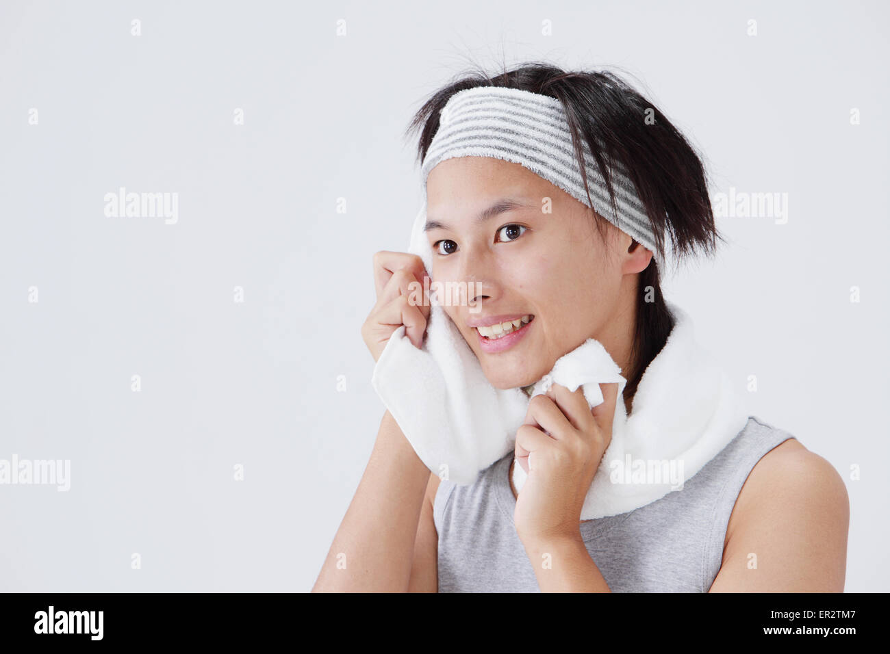 Portrait of young man wiping his face Stock Photo - Alamy