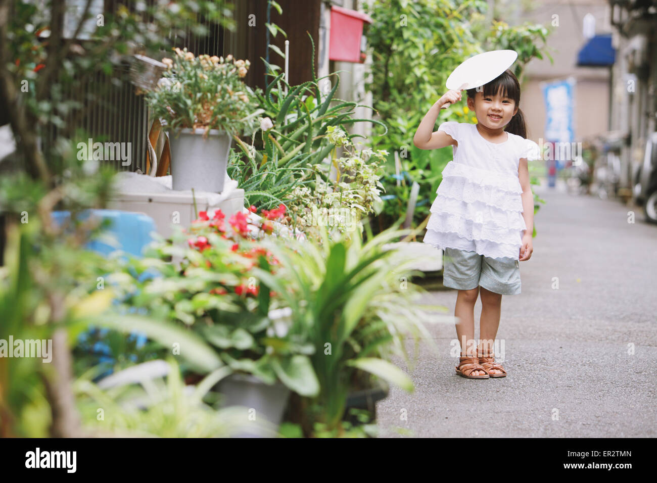 Young girl with paper fan Stock Photo - Alamy