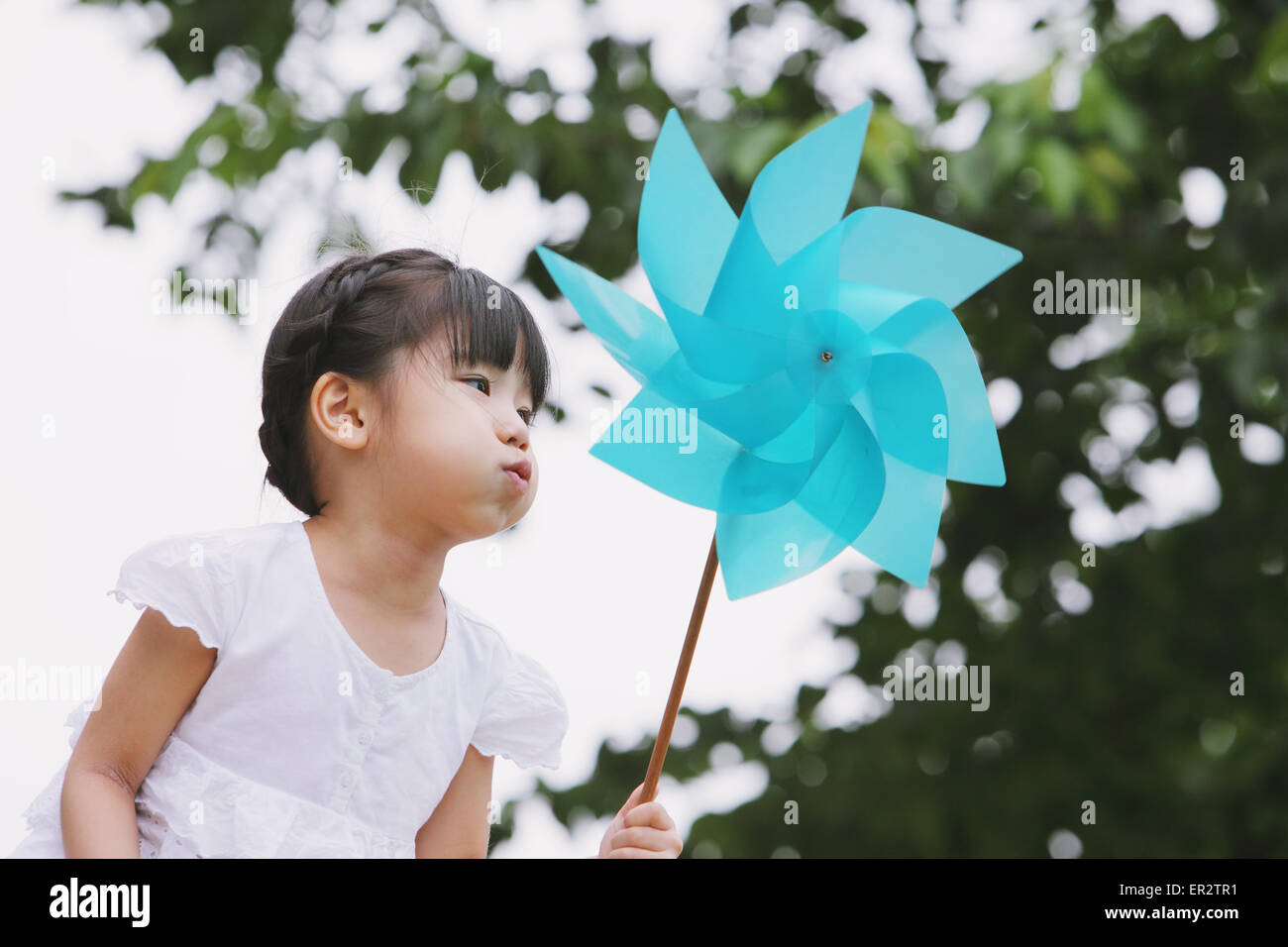 Young girl with pinwheel Stock Photo - Alamy