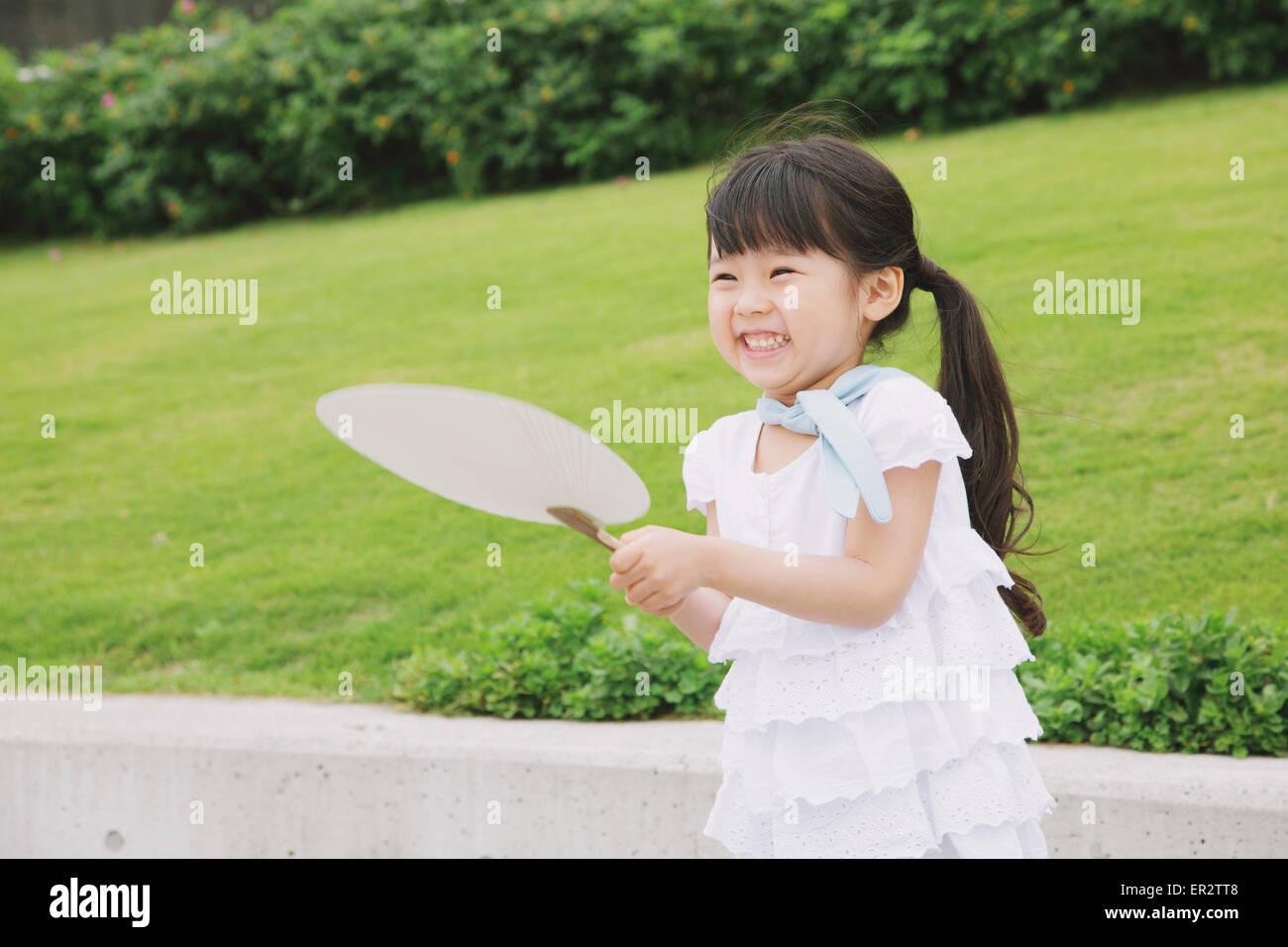 Young girl with paper fan Stock Photo - Alamy