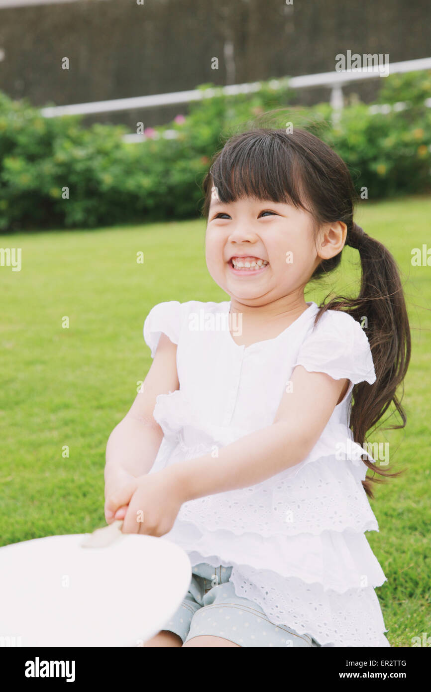 Young girl with paper fan Stock Photo - Alamy