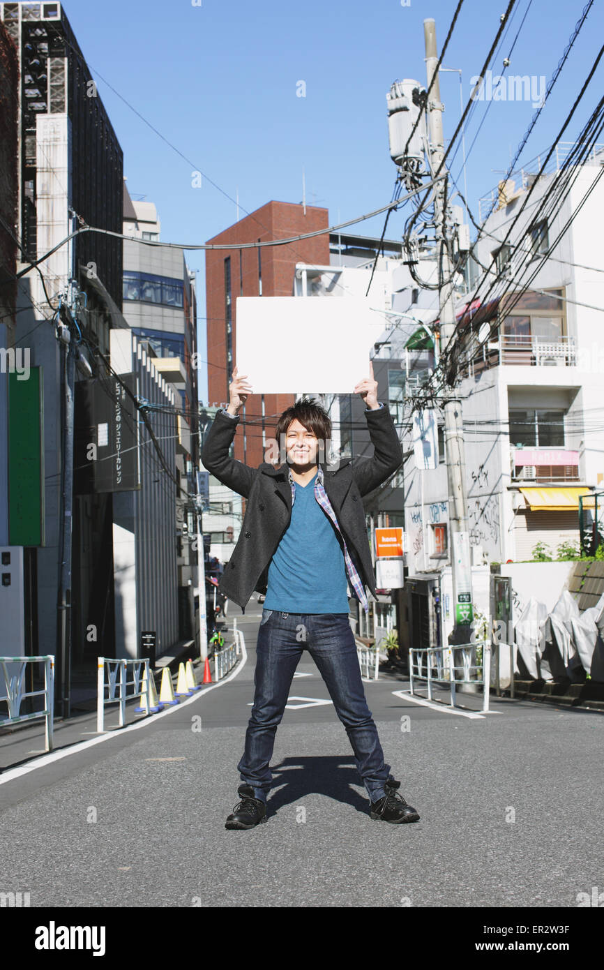 Young man with white board Stock Photo - Alamy