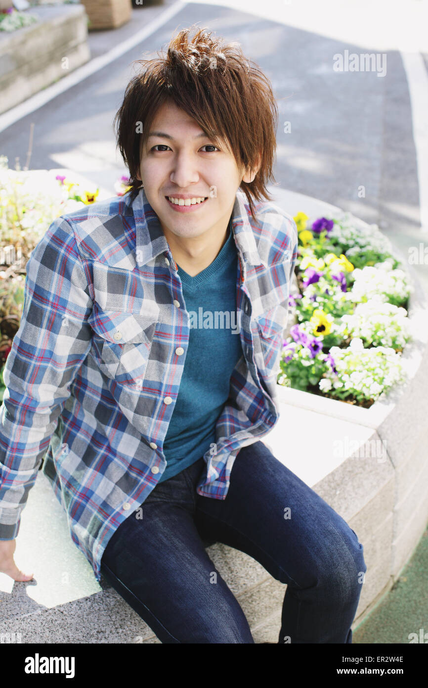 Young man smiling at camera Stock Photo - Alamy