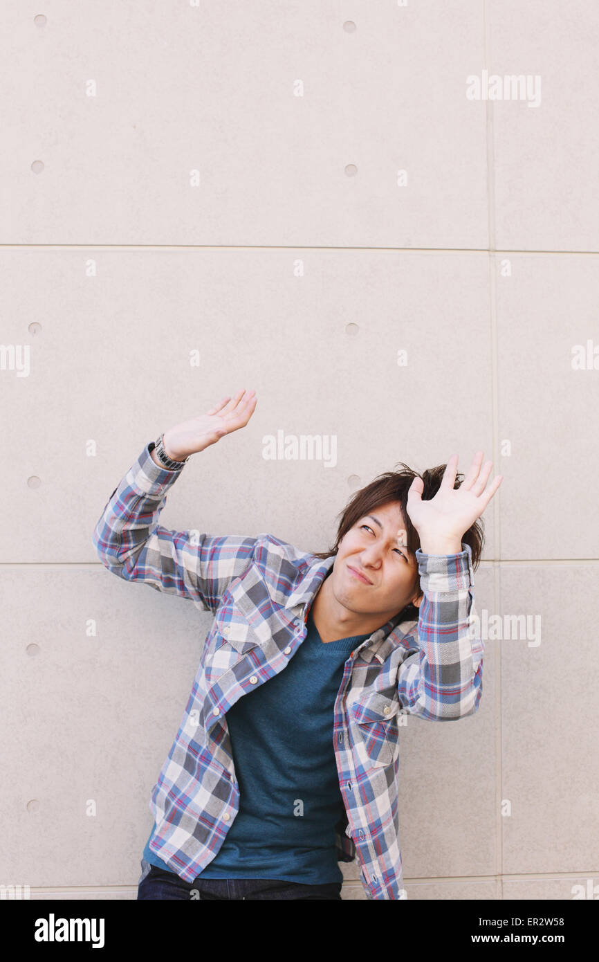 Young man hands on against a white wall Stock Photo - Alamy
