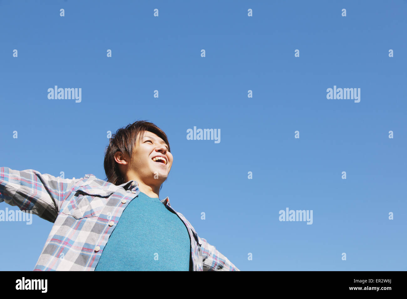 Young man spreading arms Stock Photo - Alamy
