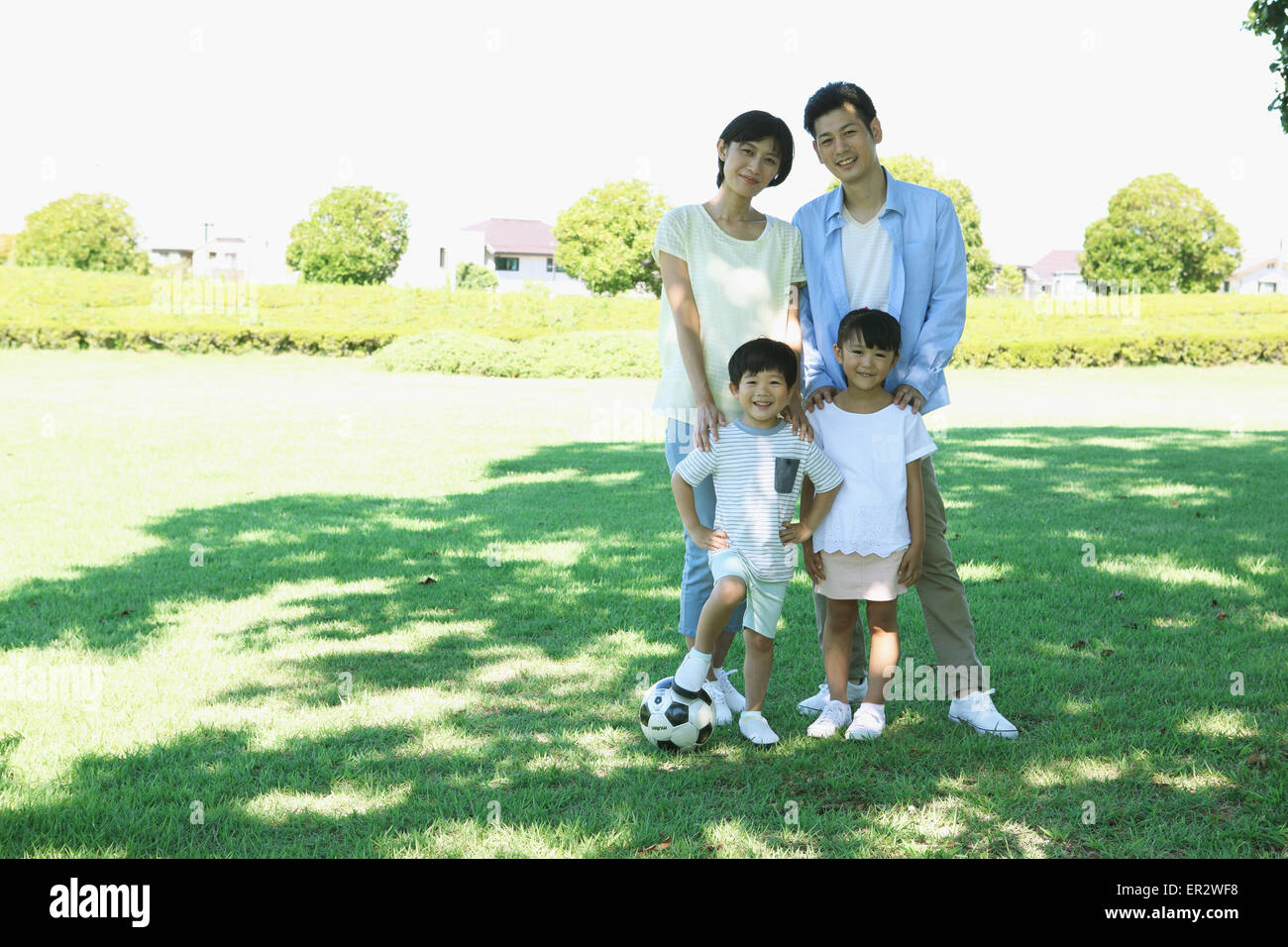 Happy Japanese family in a city park Stock Photo - Alamy