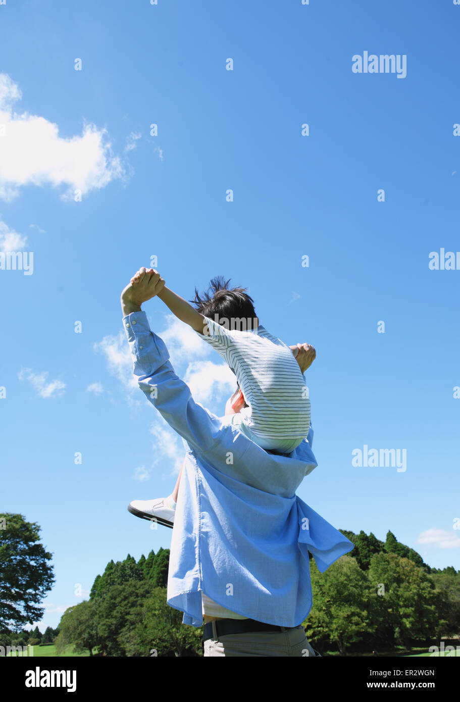 Happy Japanese father and son in a city park Stock Photo - Alamy