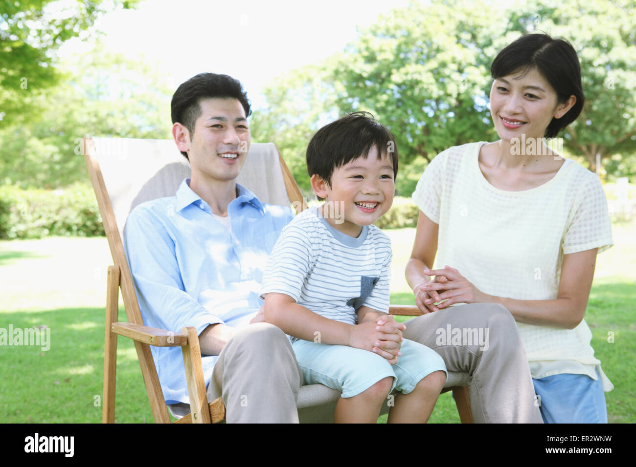 Happy family family in green hi-res stock photography and images - Alamy