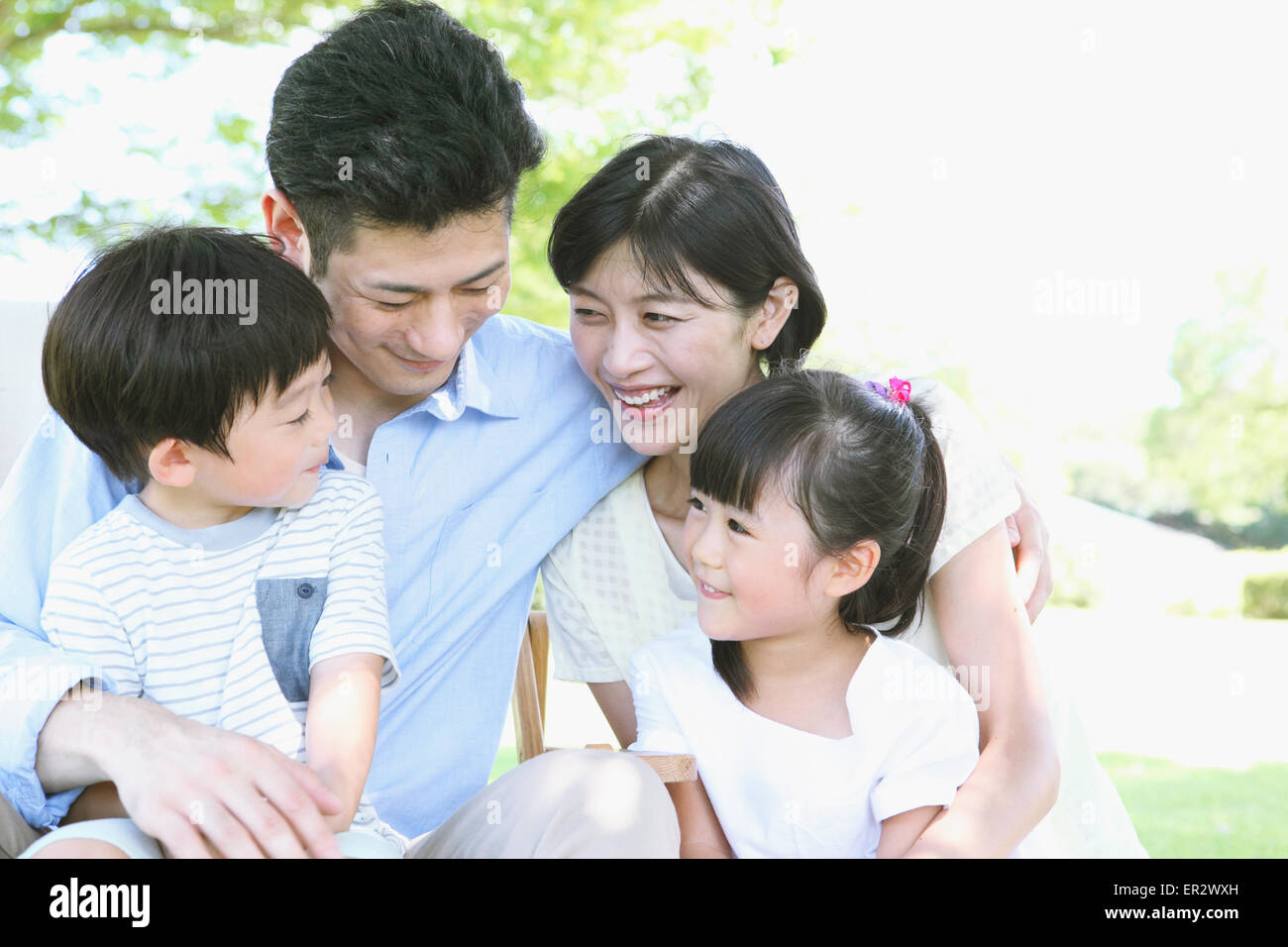 Happy Japanese family in a city park Stock Photo - Alamy