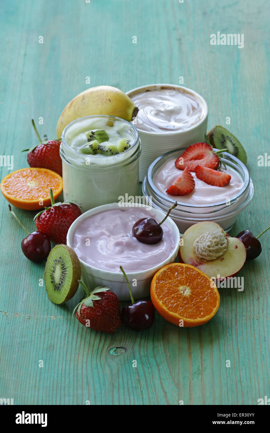 assortment of different yogurt for breakfast with berries and fruits ...