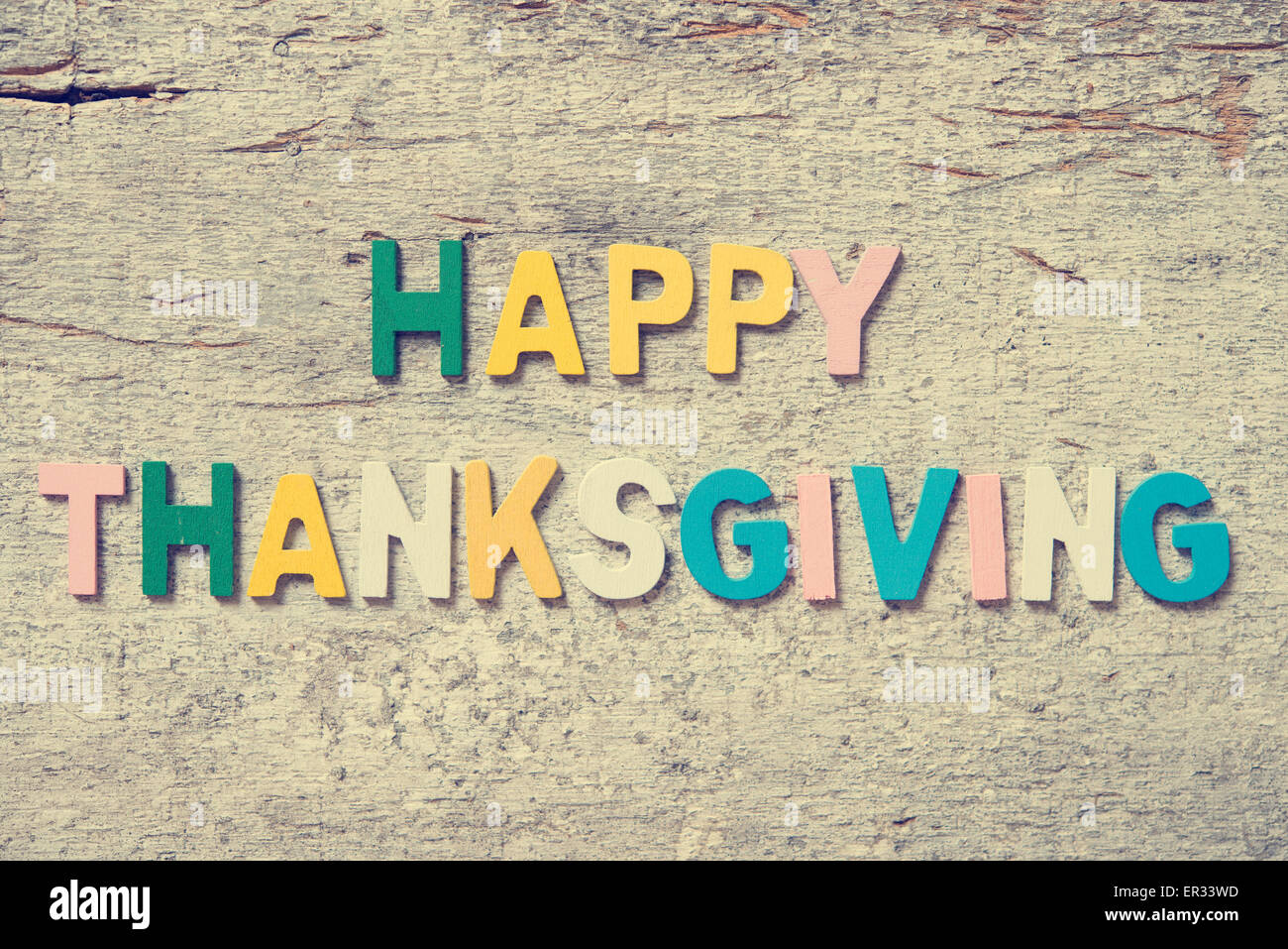 The colorful words "HAPPY THANKSGIVING" made with wooden letters on old ...