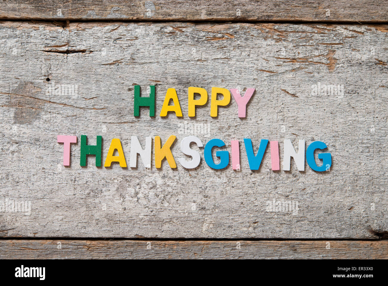 The colorful words "HAPPY THANKSGIVING" made with wooden letters on old ...
