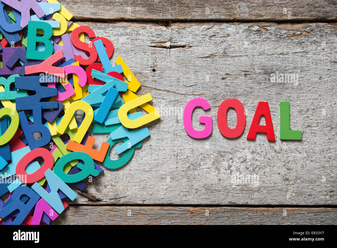 The colorful words "GOAL" made with wooden letters next to a pile of ...