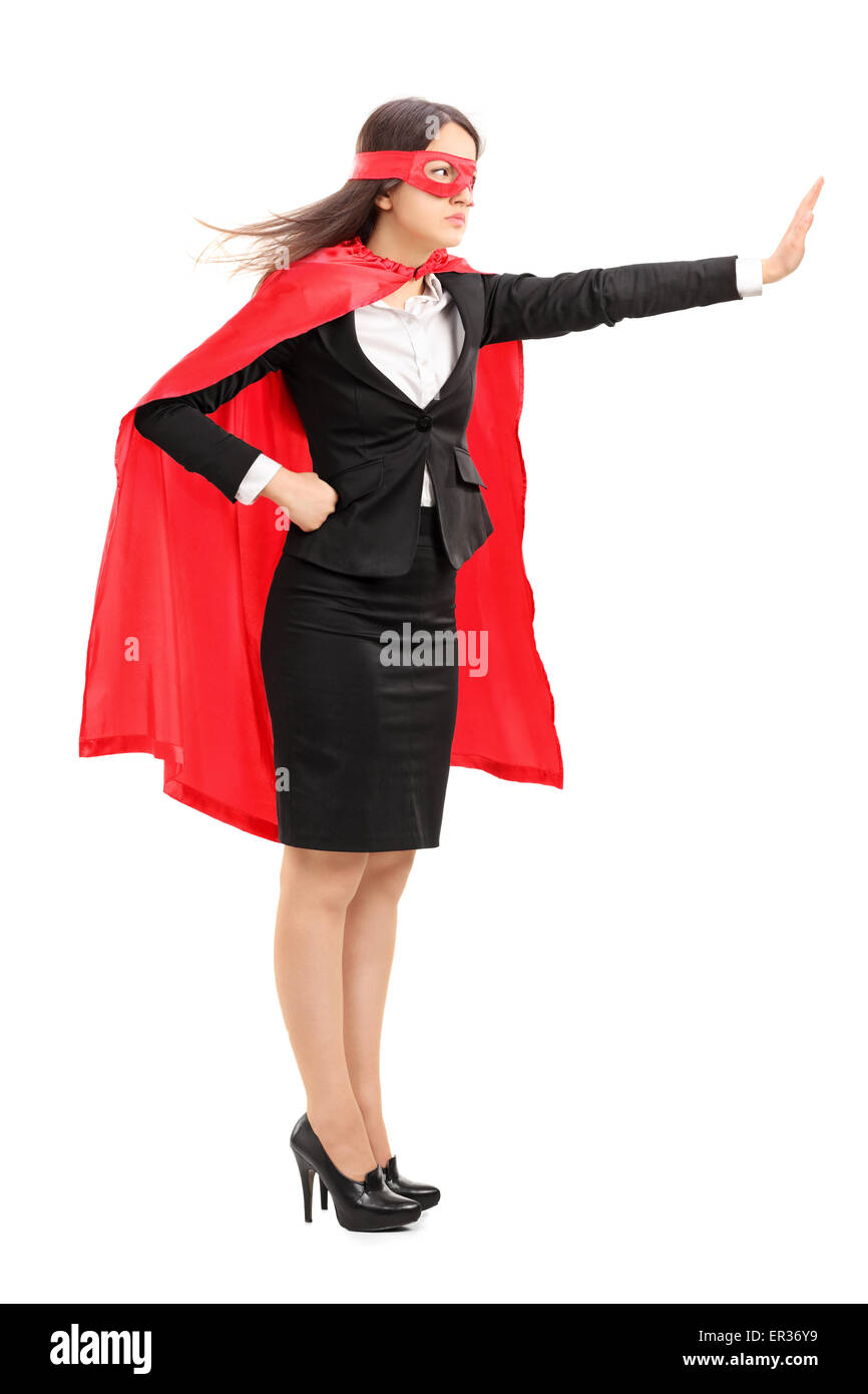 Full length portrait of a female superhero making a stop sign with her ...