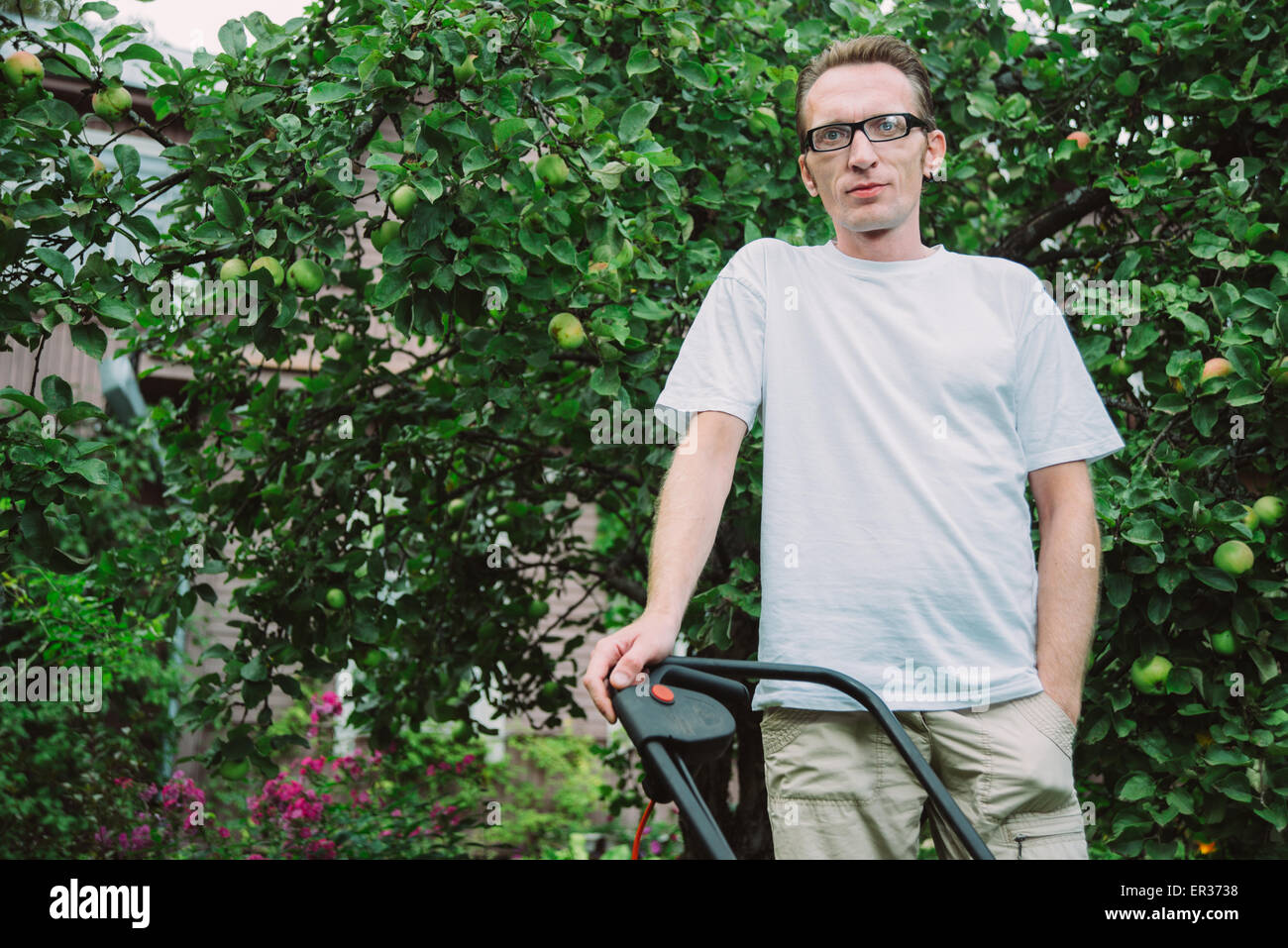 man with lawn mower Stock Photo - Alamy