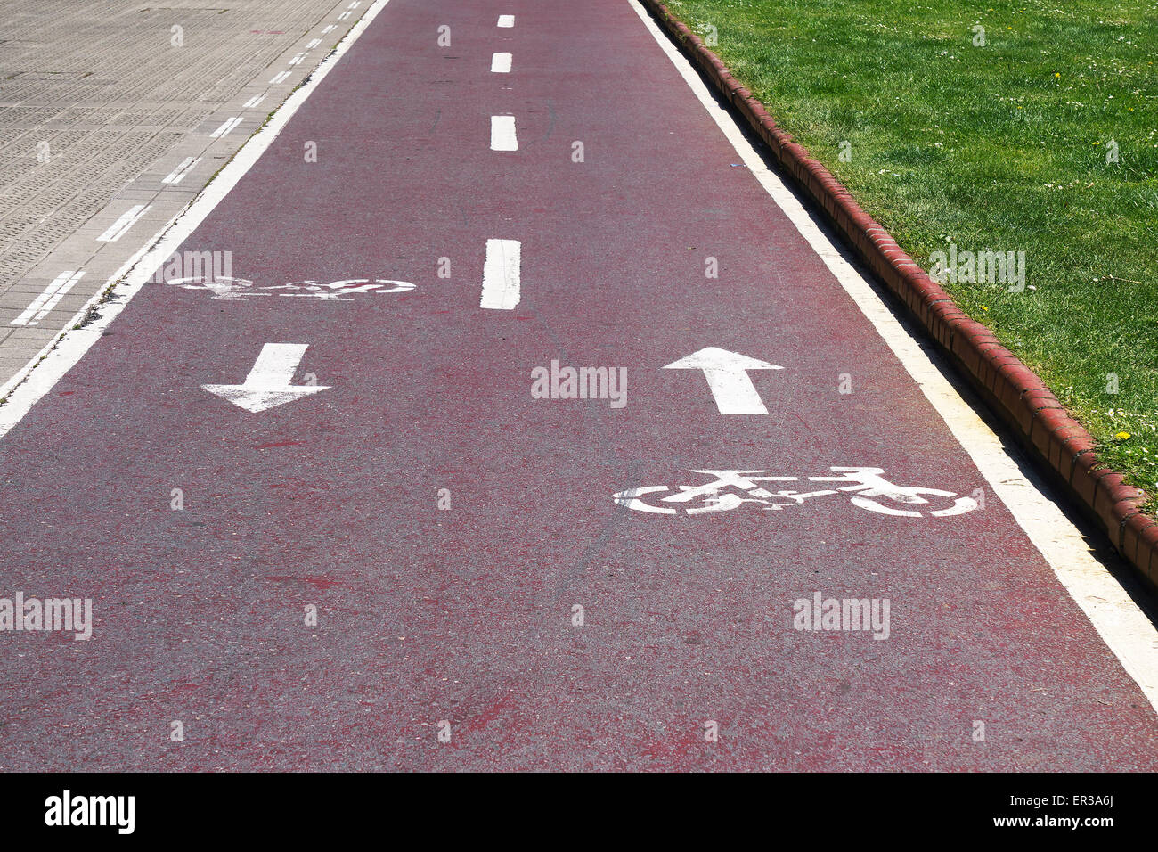 red bike lane with symbols Stock Photo - Alamy