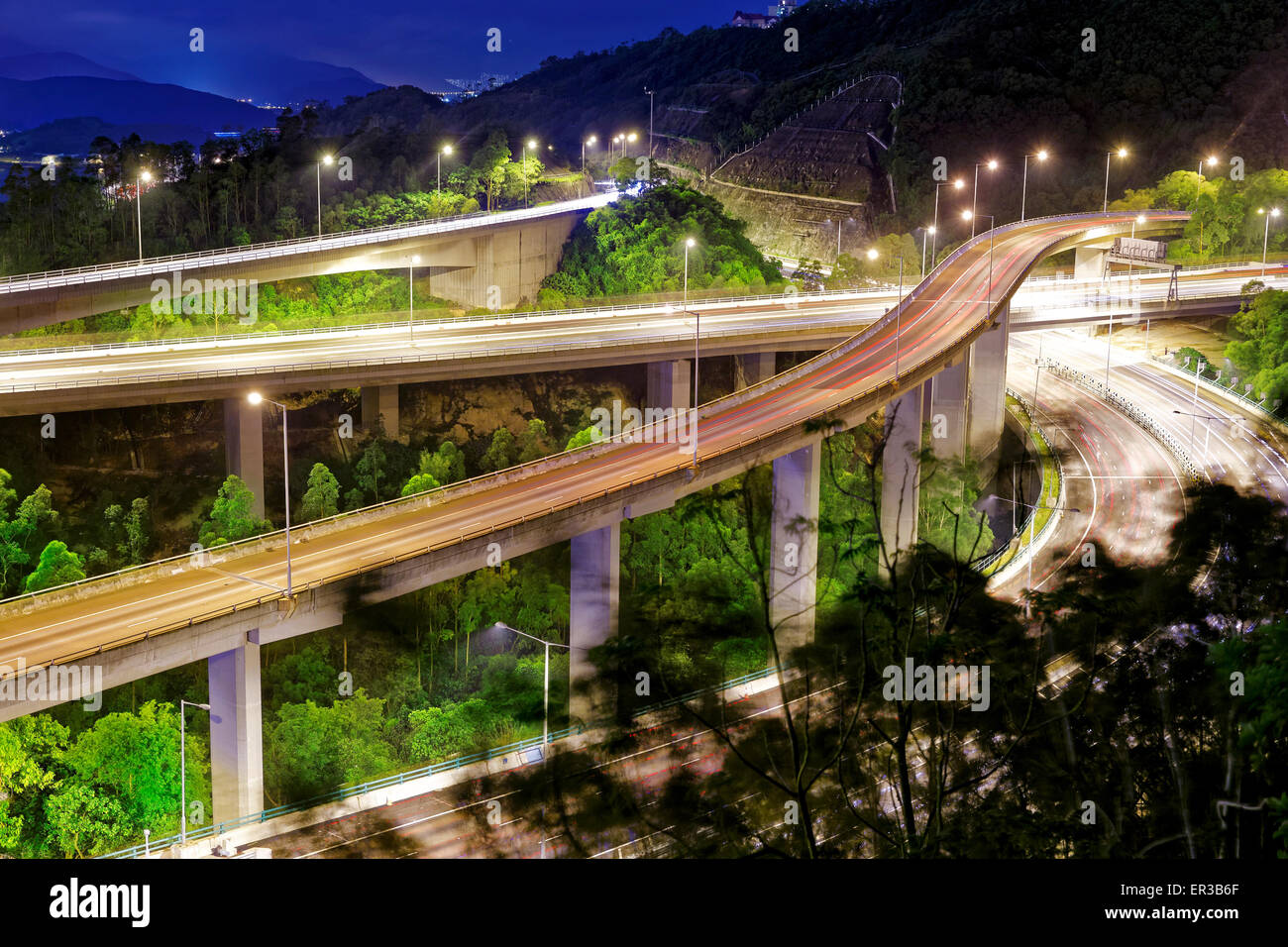 moving car on highway bridge with light through city at night Stock ...