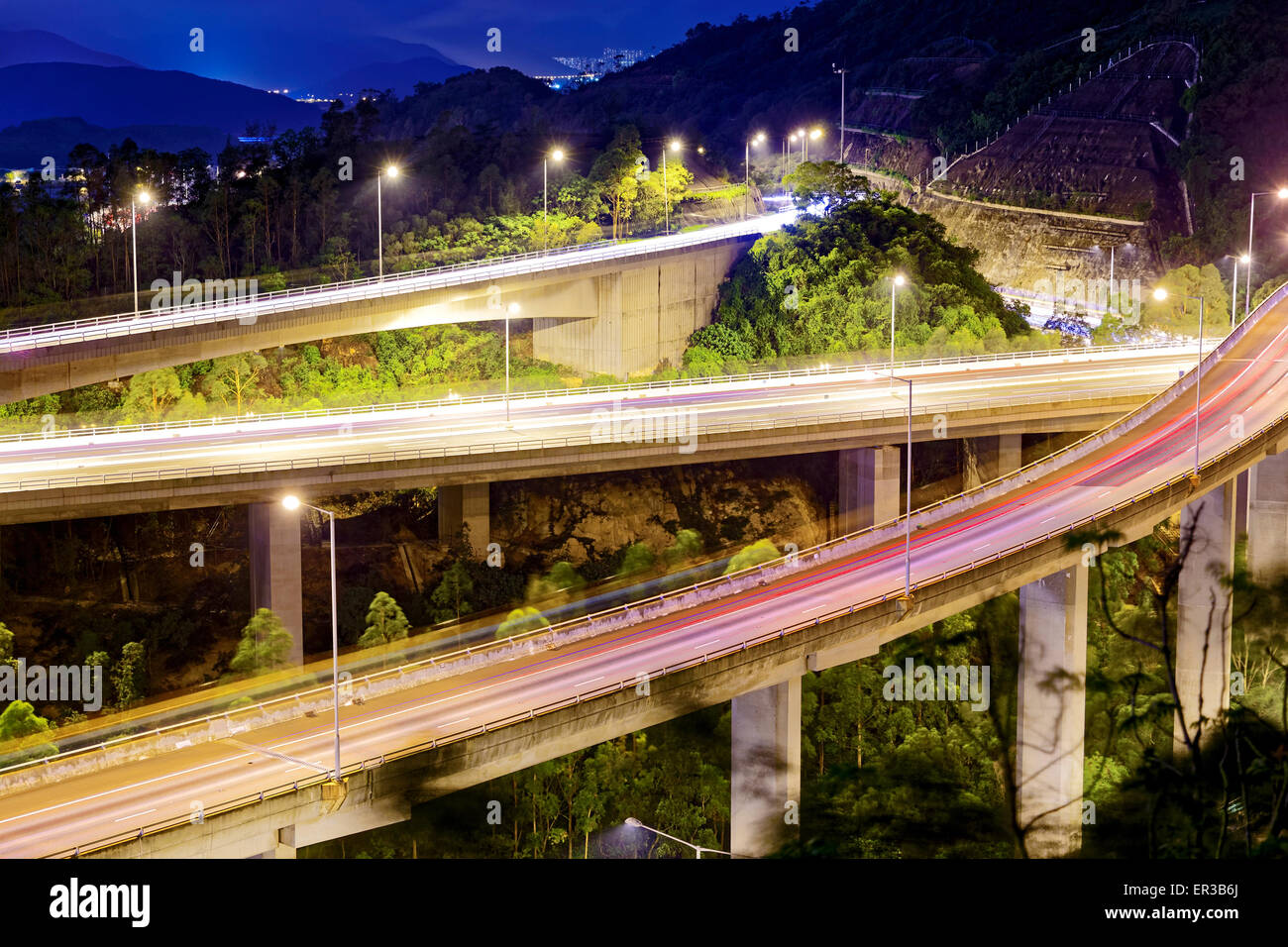 moving car on highway bridge with light through city at night Stock ...