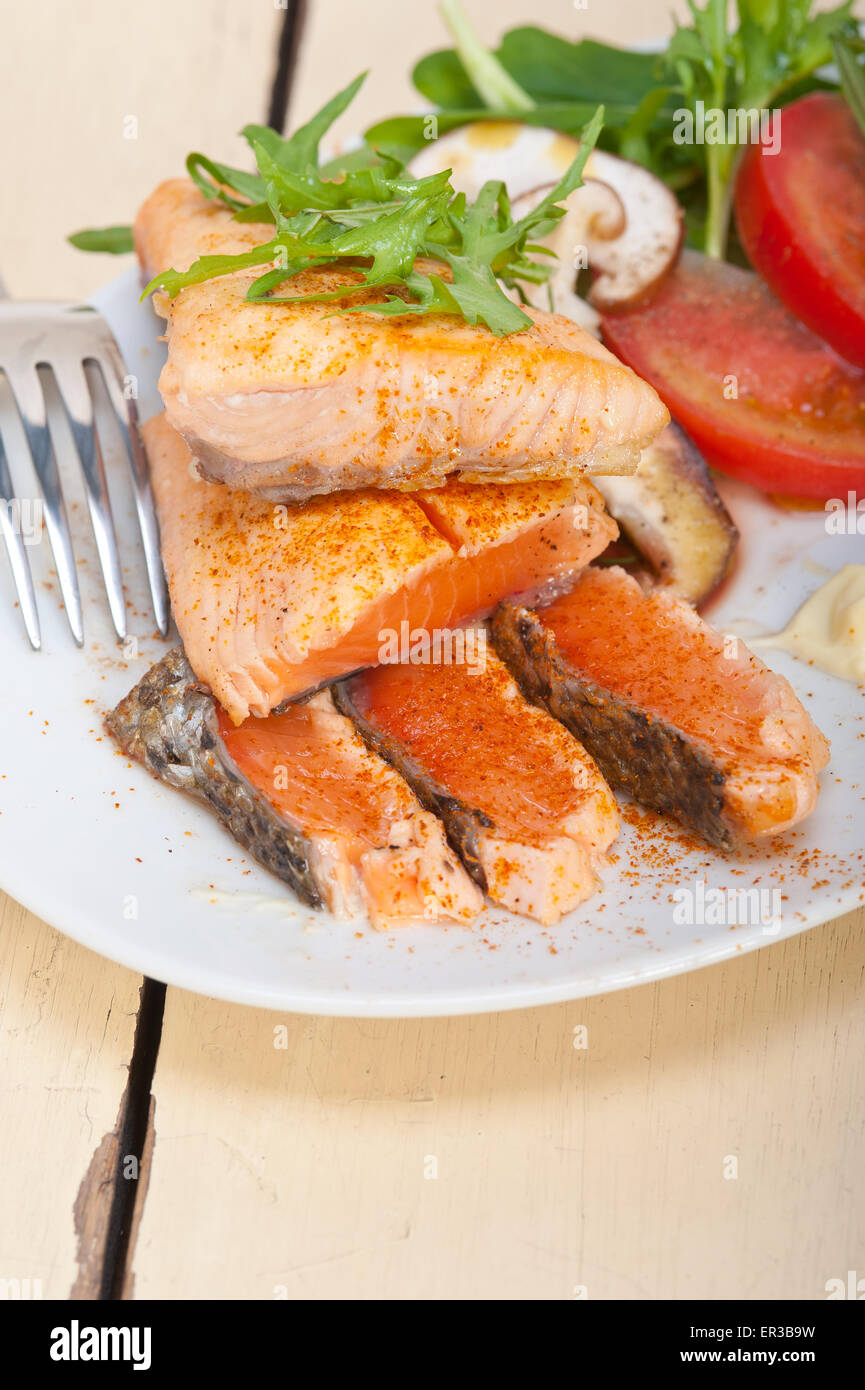 grilled fresh samon filet with vegetables salad tomato arugula ...
