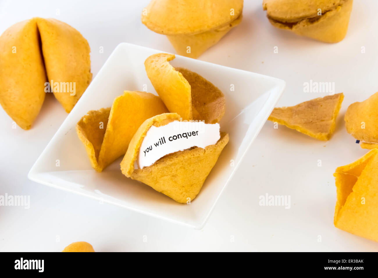 open fortune cookie with strip of white paper - YOU WILL CONQUER Stock ...